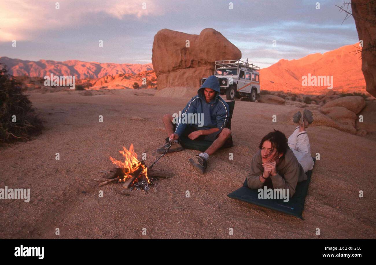 Couple at a bonfire, Tafraout, Morocco, Africa Stock Photo - Alamy