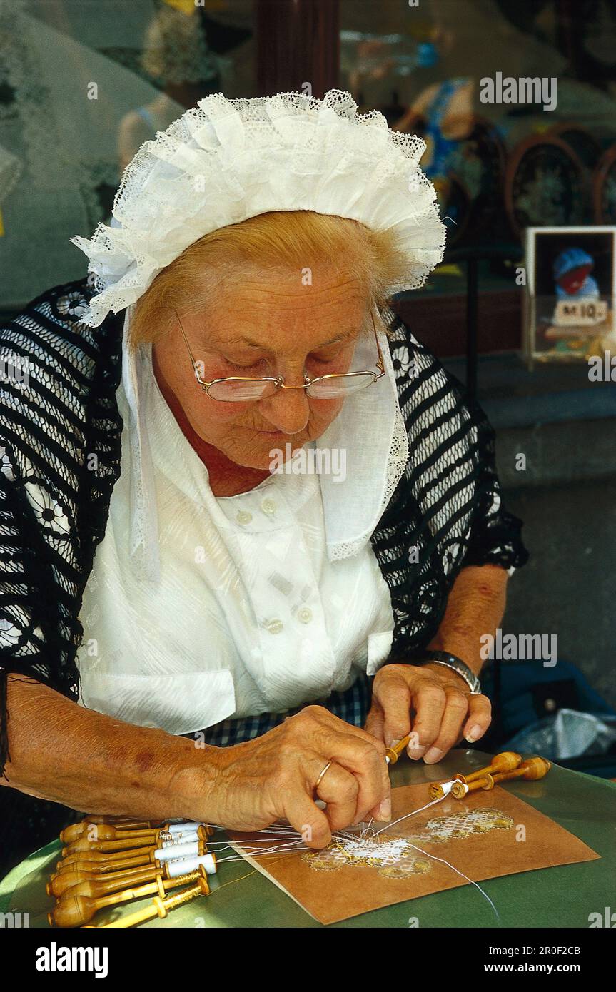 Lacemaker wearing traditional costumes, Bruges, Flanders, Belgium ...