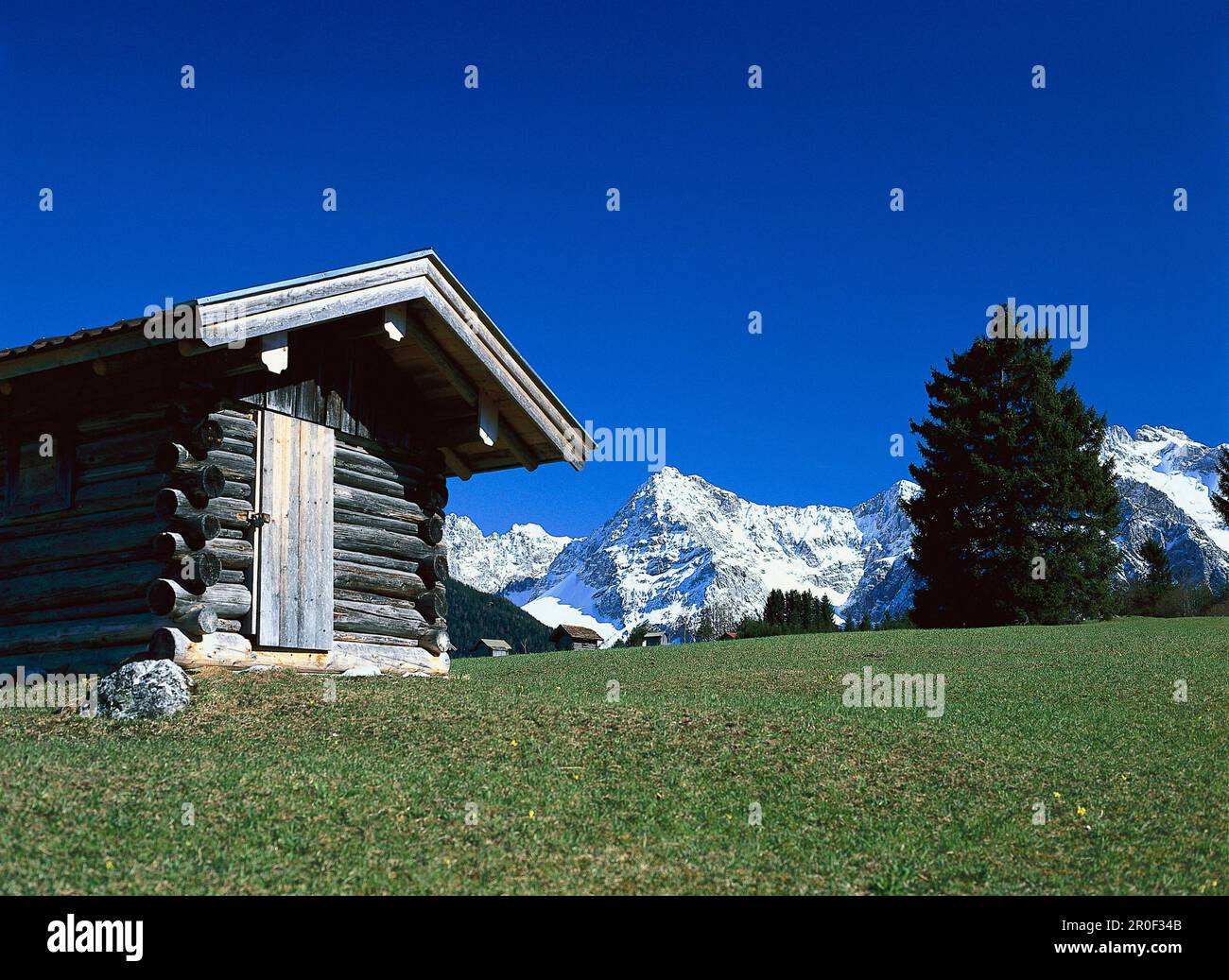 Log cabin with Karwendel mountain range in the background, Bavarian ...