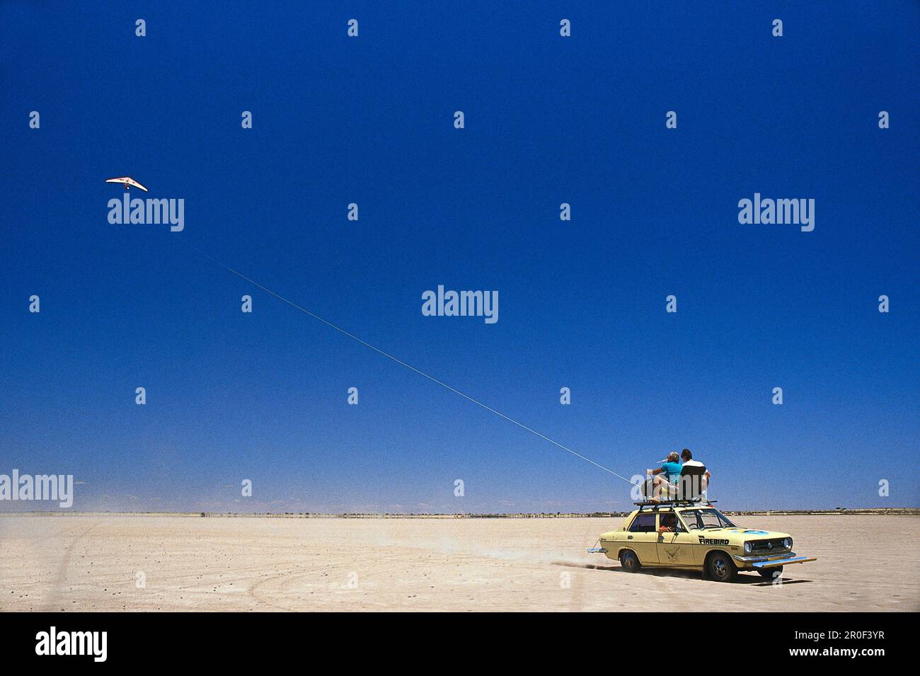 Two People on a car in the desert, hang-gliding in Namibia, Africa ...