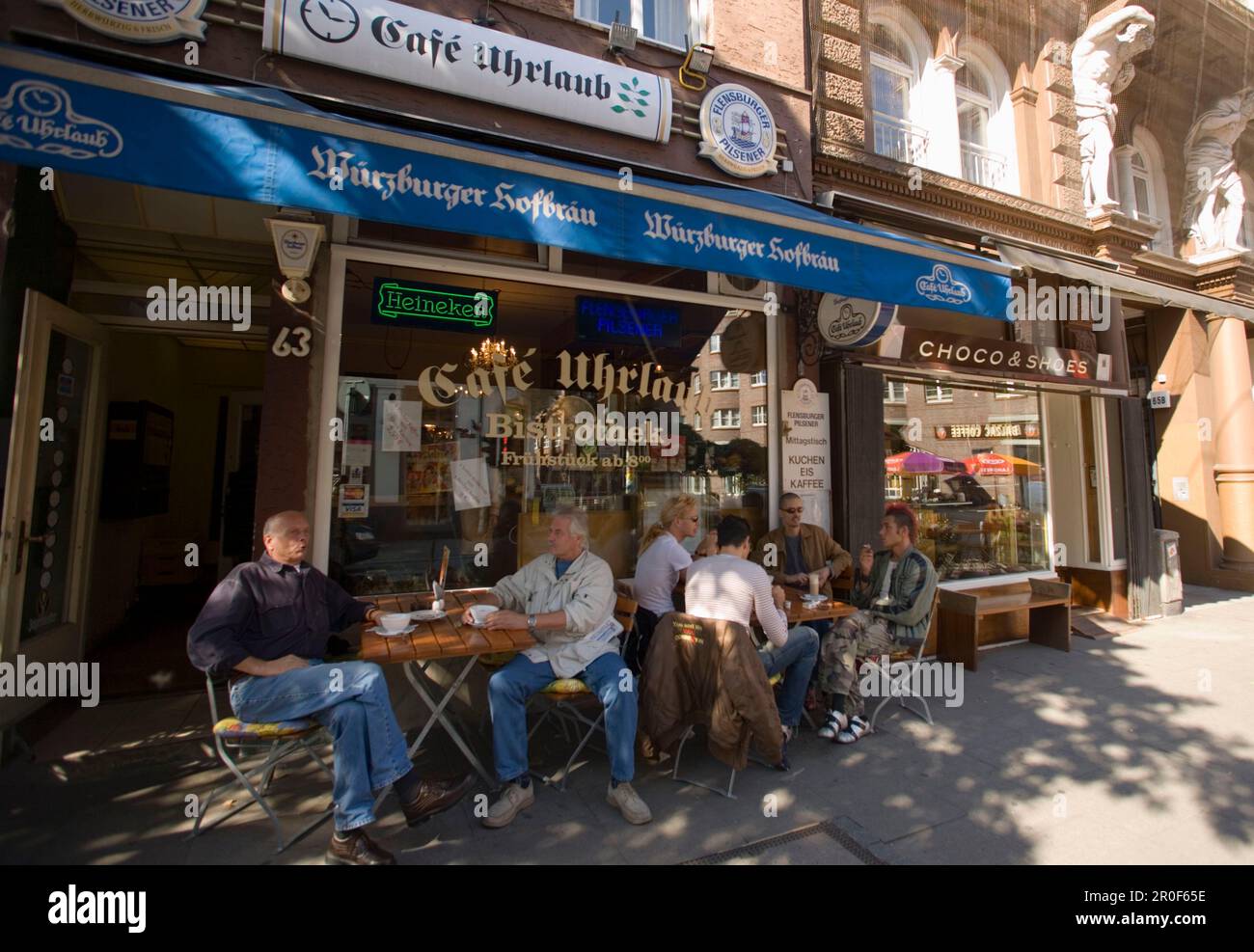 People sitting outside of Cafe Uhrlaub at St. Georg street, Hamburg ...