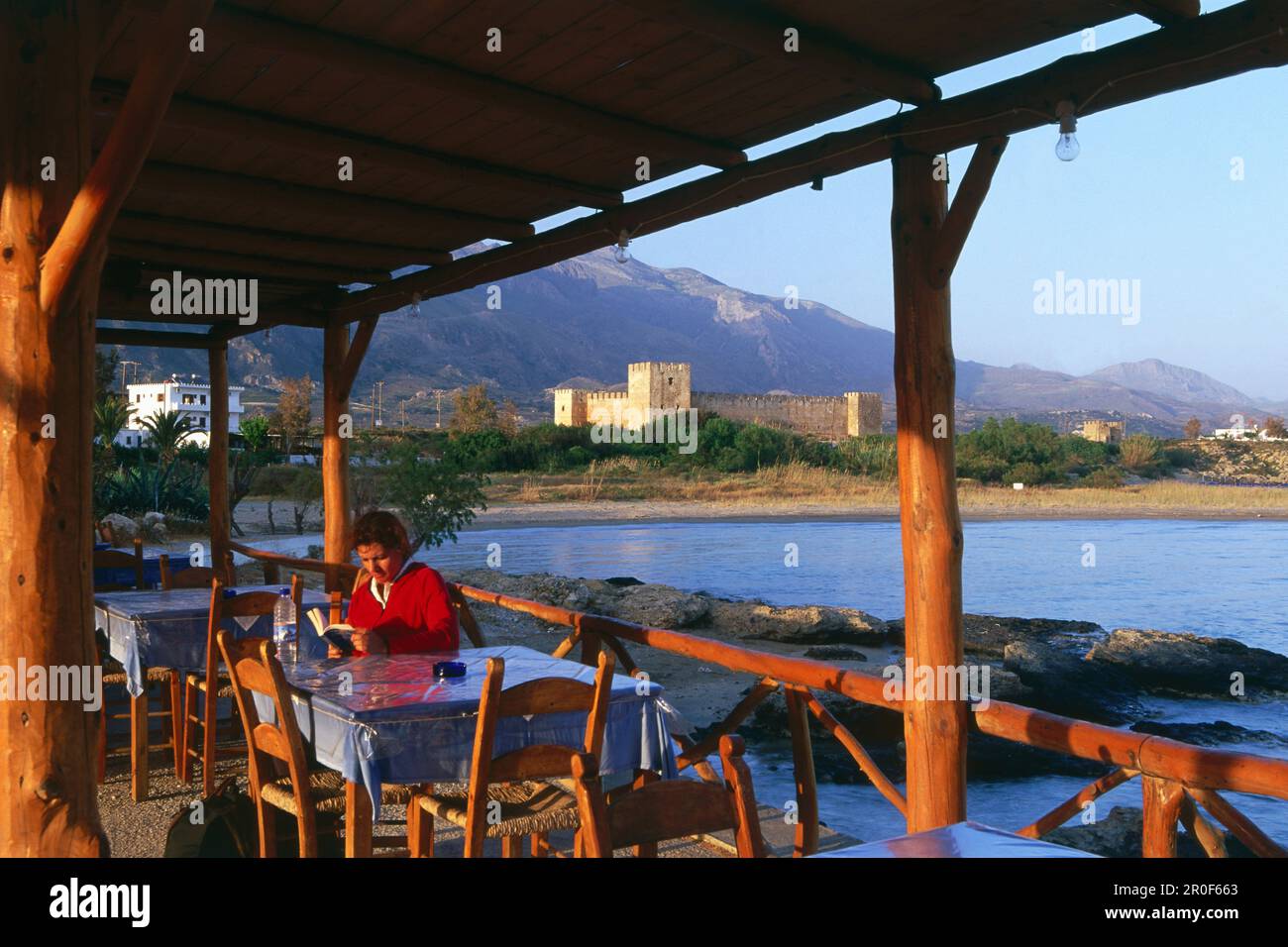 Woman sitting in tavern, Castle, Frangokastello, Crete, Greece Stock ...