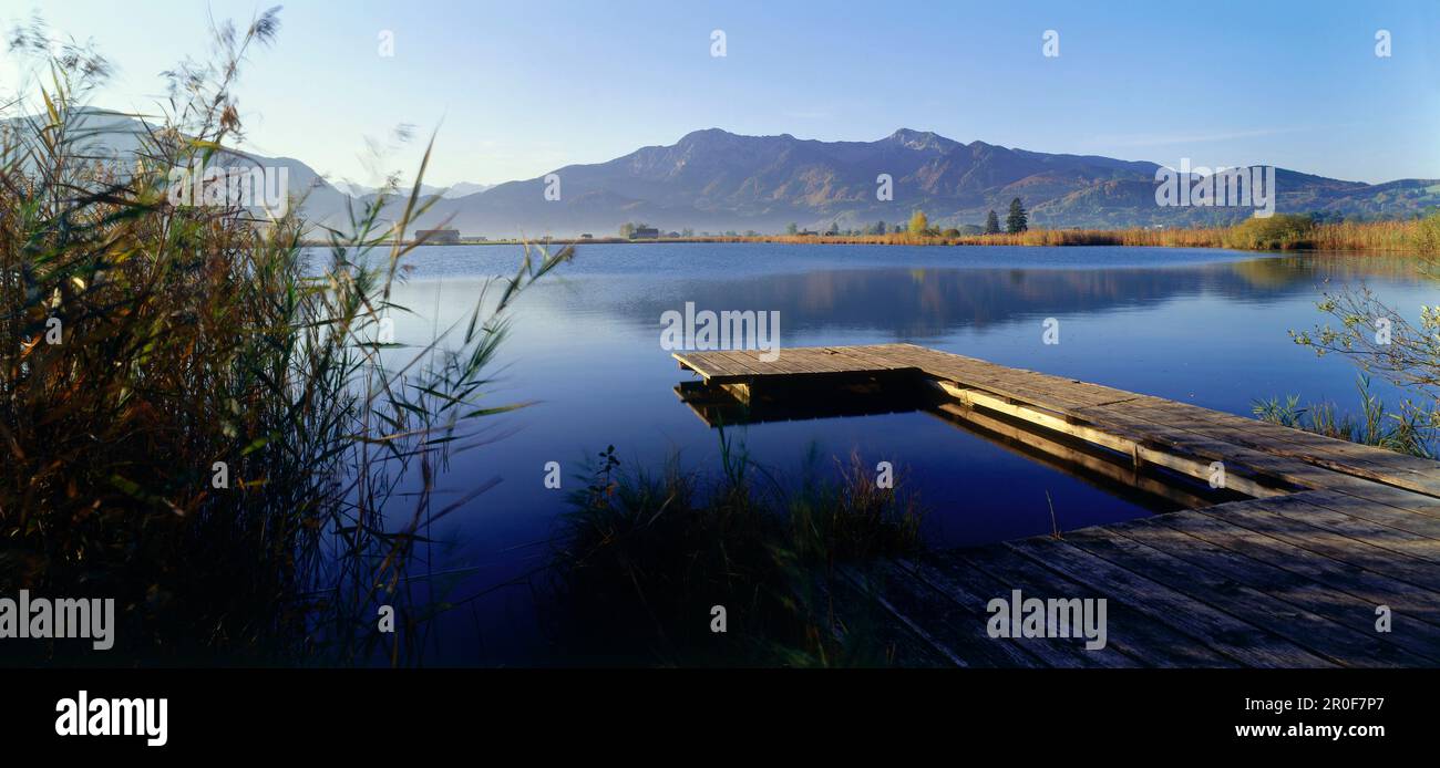 Wooden pier over body of water, Lake Eichsee, Upper Bavaria, Germany ...