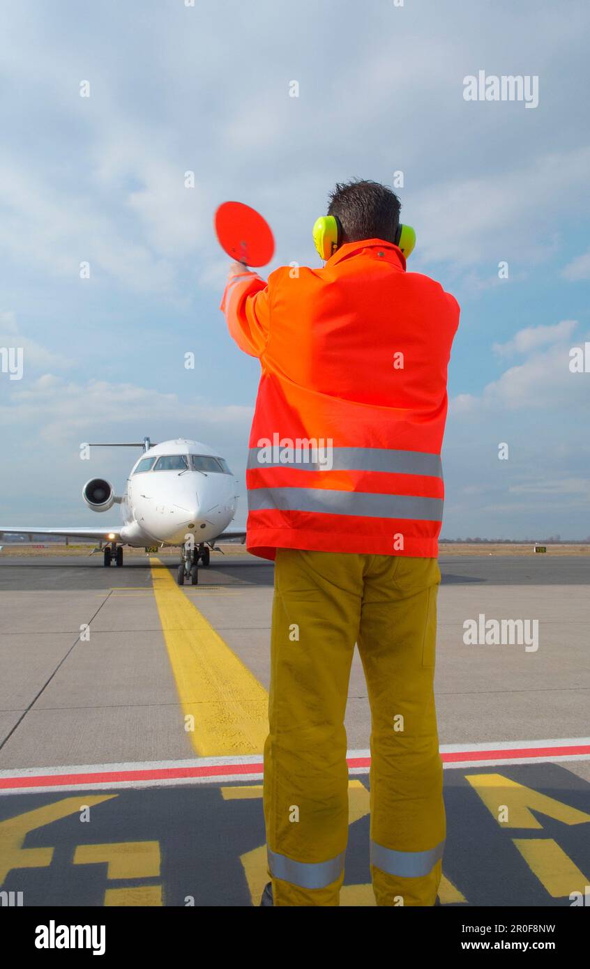 Airport ground crew signaling to aircraft, Airport Düsseldorf, North ...