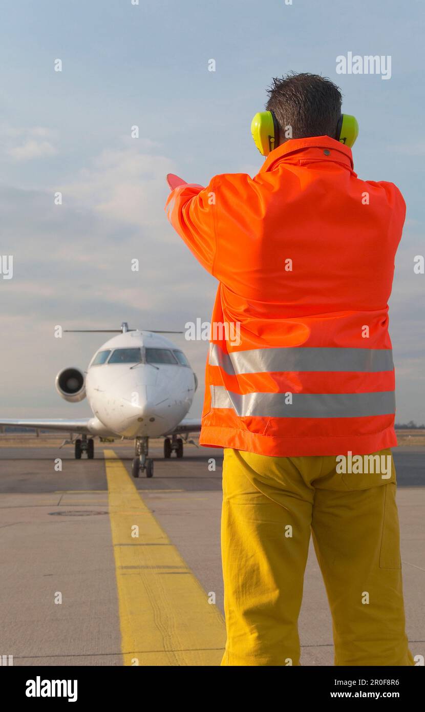 Airport ground crew signaling to aircraft, Airport Düsseldorf, North ...
