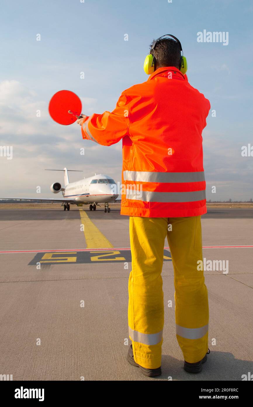 Airport ground crew signaling to aircraft, Airport Düsseldorf, North ...