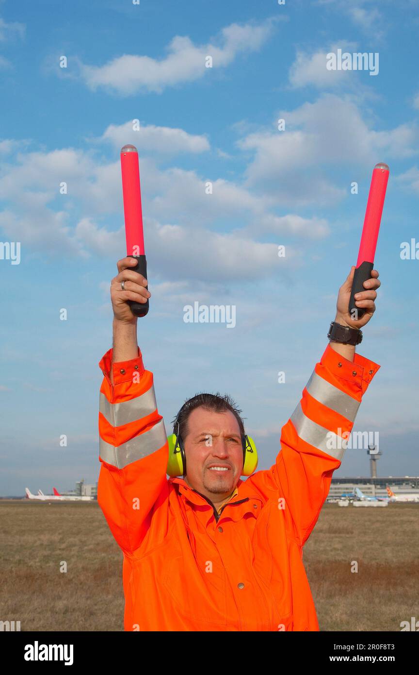 Airport ground crew signaling to aircraft, Airport Düsseldorf, North ...