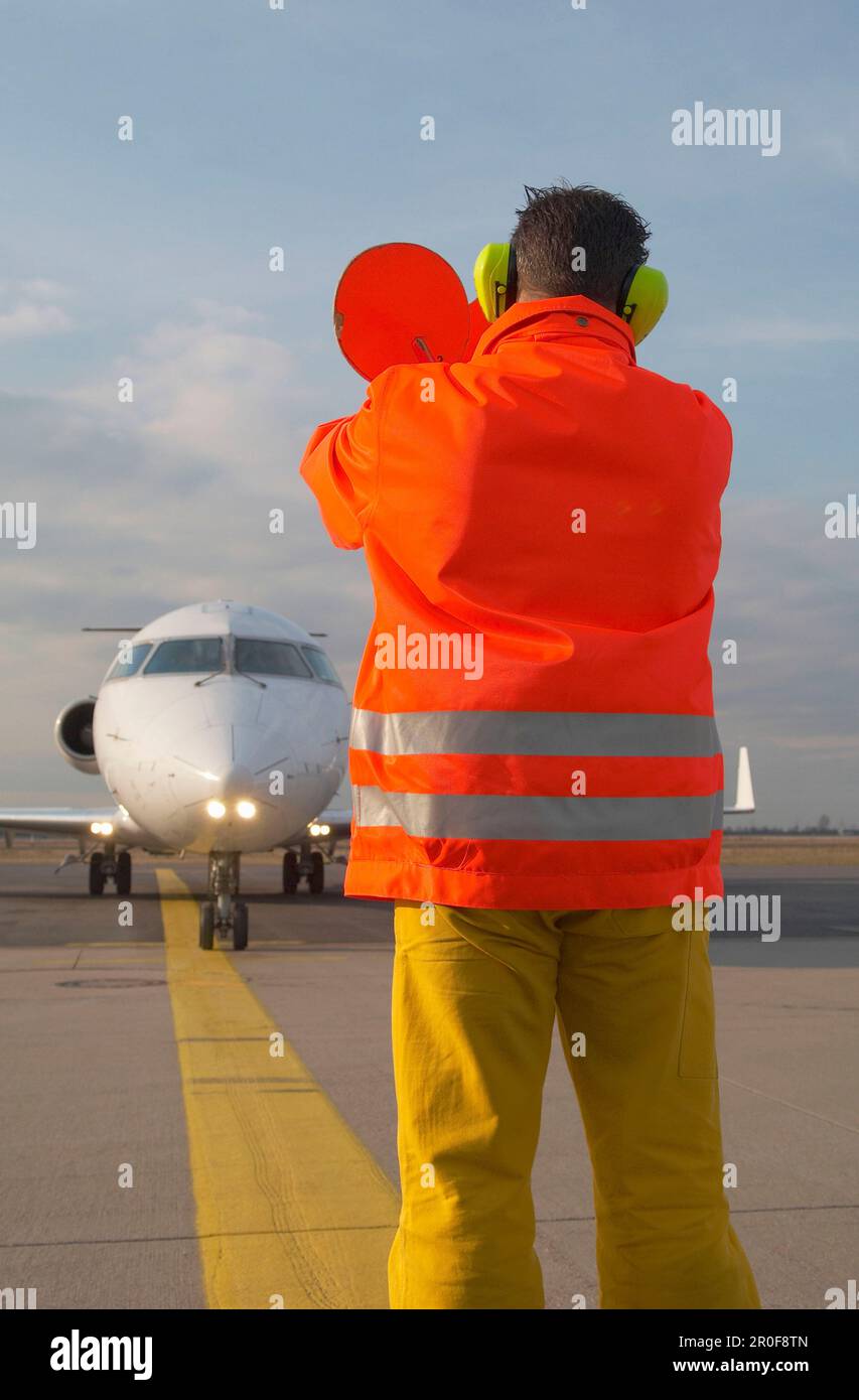 Airport ground crew signaling to aircraft, Airport Düsseldorf, North ...