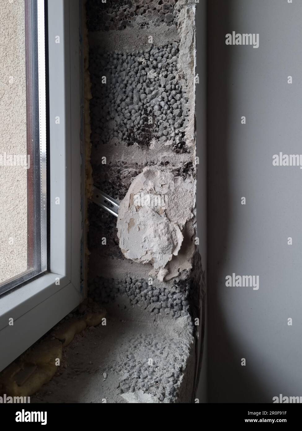 Old mounting foam between a pvc window and a brick wall. Dismantling of ...