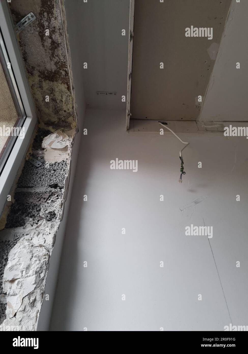 Old mounting foam between a pvc window and a brick wall. Dismantling of ...