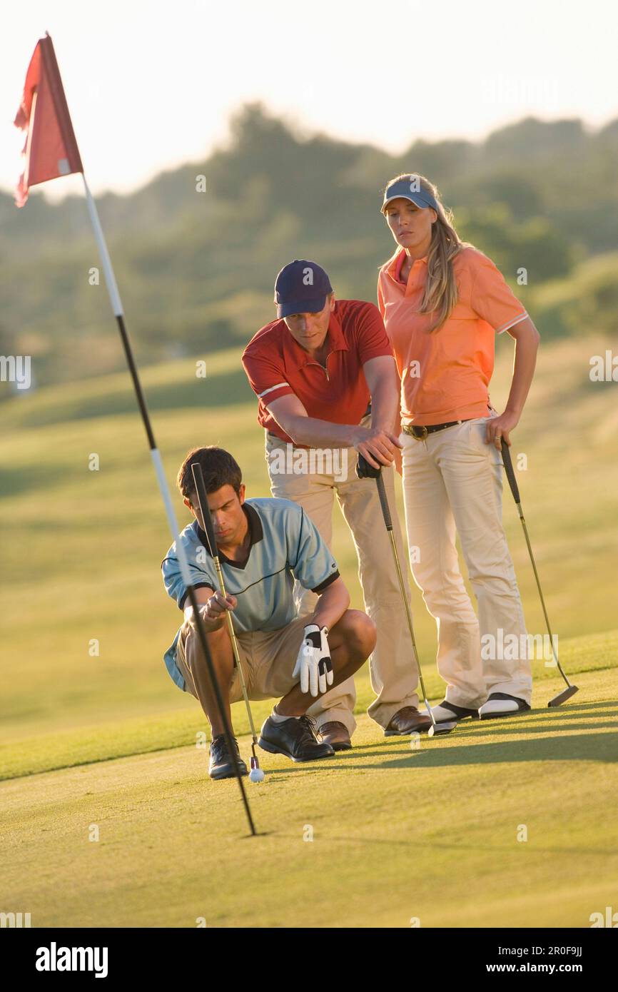 Male golfer crouching behind golf hi-res stock photography and images ...