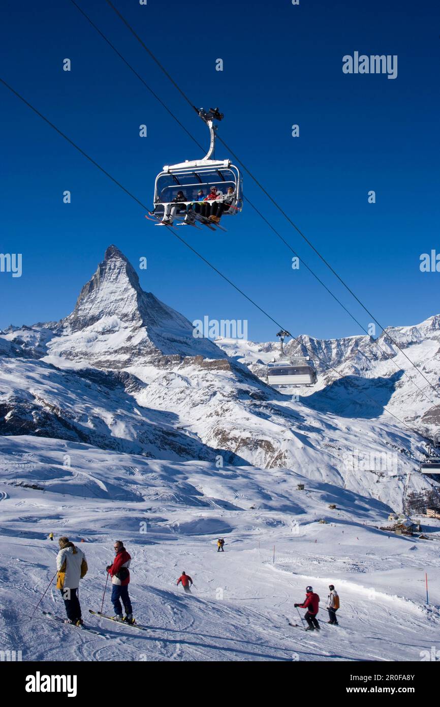 People on ski lift and slope, Matterhorn in background, Zermatt, Valais ...