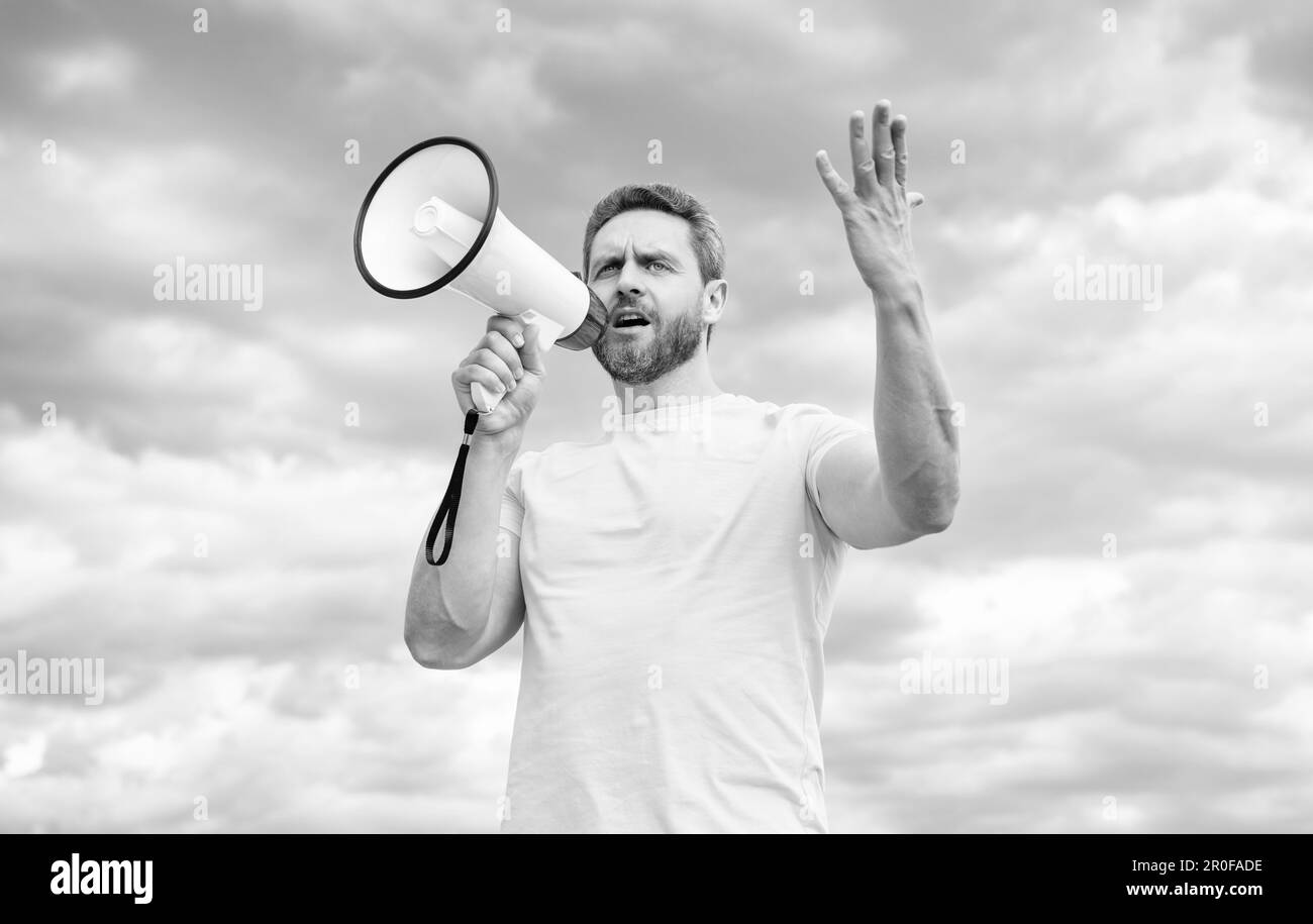 man in yellow shirt speaking in loudspeaker on sky background Stock ...