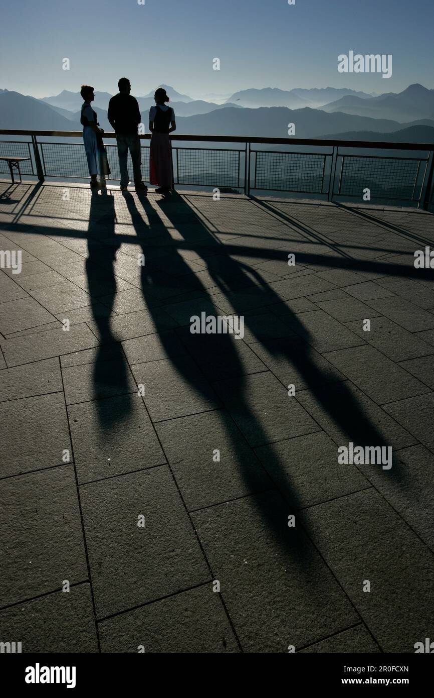 Two waitresses and a waiter standing on the terrace of Brauneckhaus ...