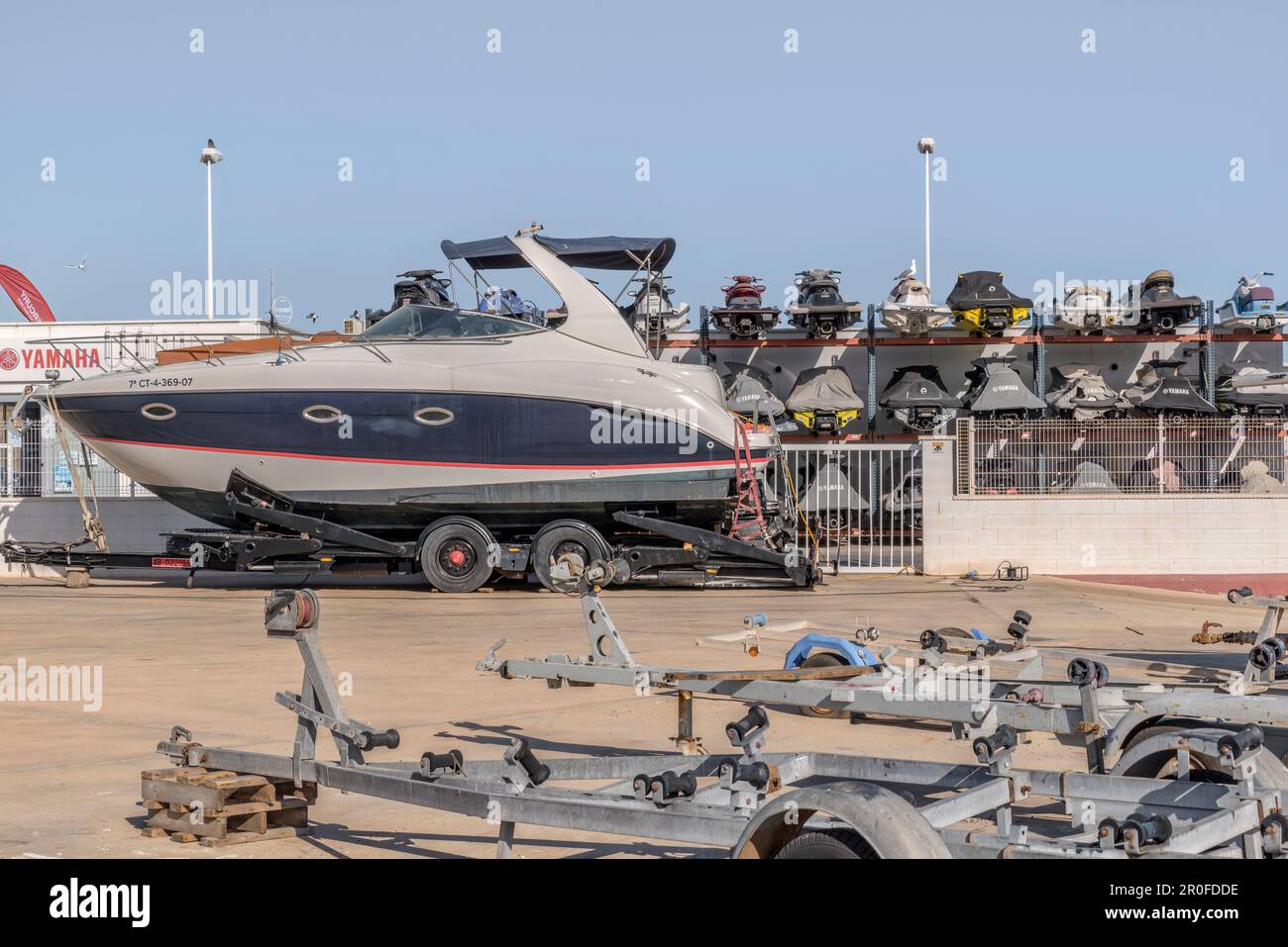 slipway with trailers for boats and yachts and a rack of jet skis at a ...