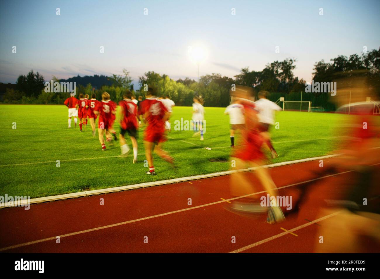 Soccer teams running on field Stock Photo - Alamy