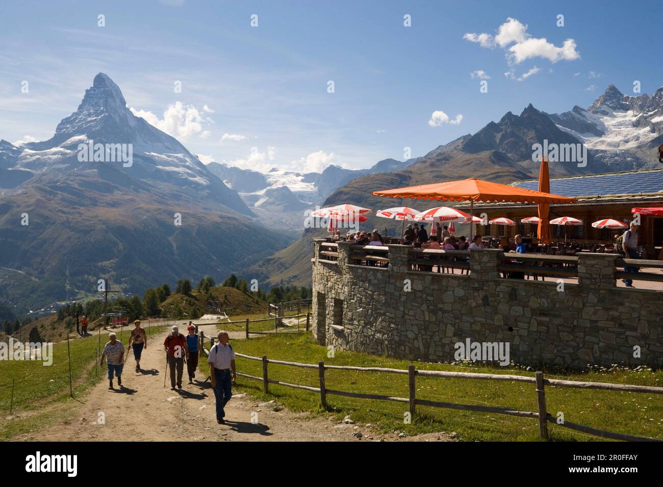Hikers arriving the restaurant Blauherd, Matterhorn (4478 metres) in ...