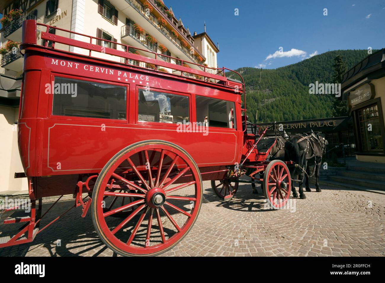 Red carriage of the Mont Cervin Palace parking in front of the Hotel ...
