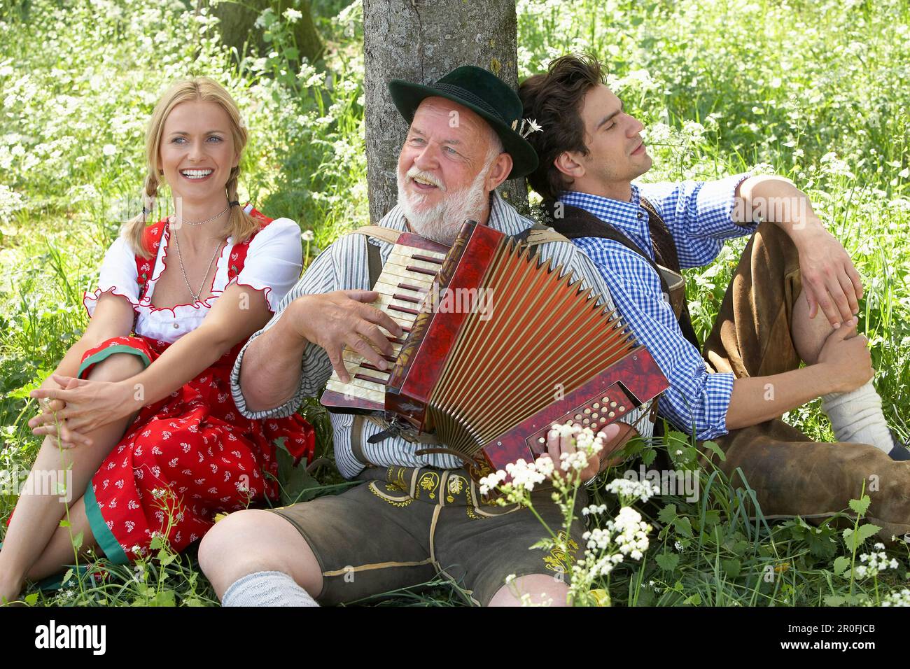 Couple listening to man playing melodeon Stock Photo - Alamy