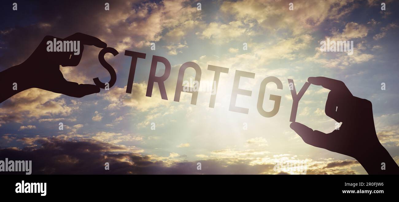 Strategy - human hands holding black silhouette word Stock Photo - Alamy