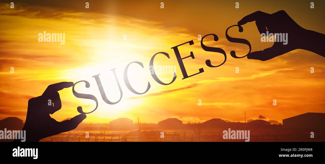 Success - human hands holding black silhouette word Stock Photo - Alamy