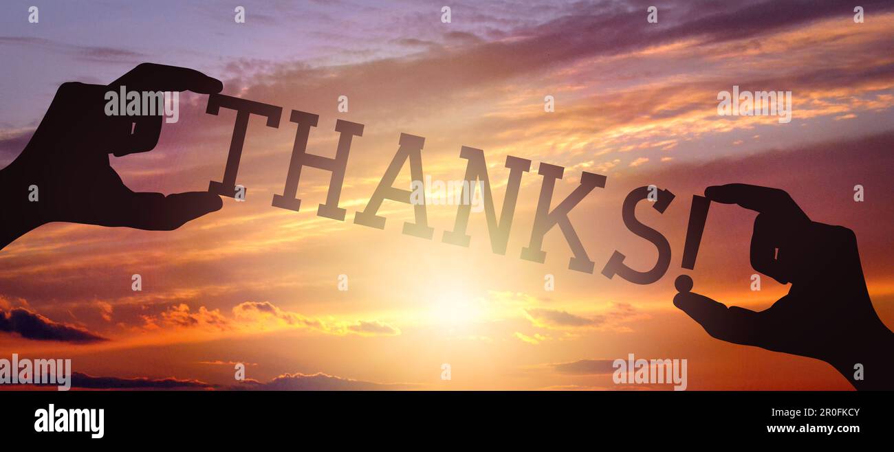 Thanks - human hands holding black silhouette word Stock Photo - Alamy