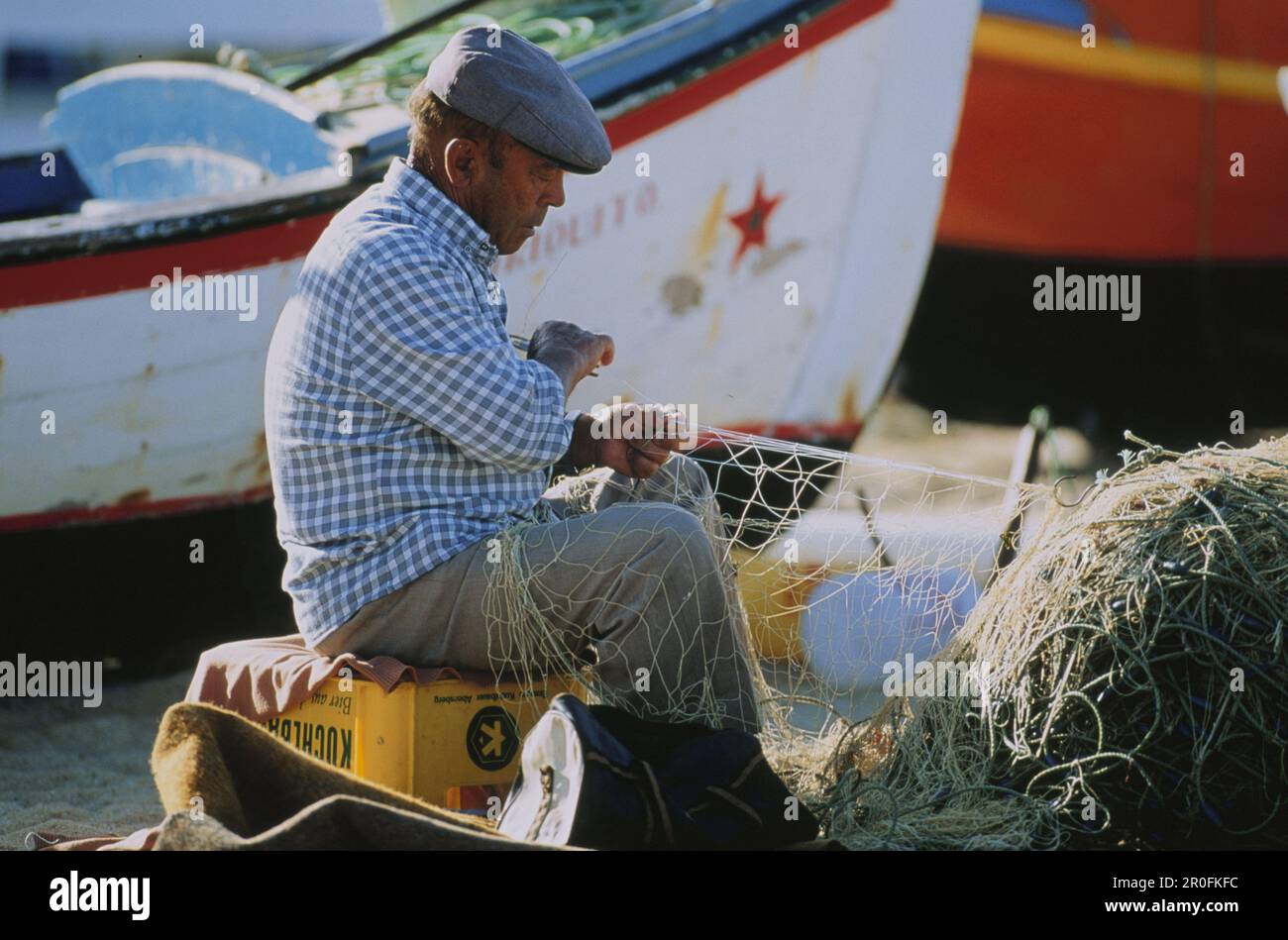 Fisherman repairing net, Albufeira, Portugal Stock Photo - Alamy