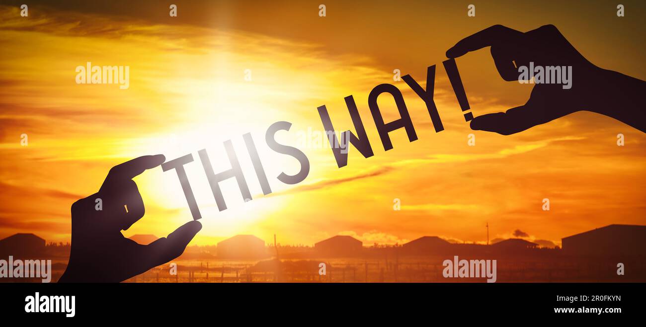 This way - human hands holding black silhouette words Stock Photo - Alamy