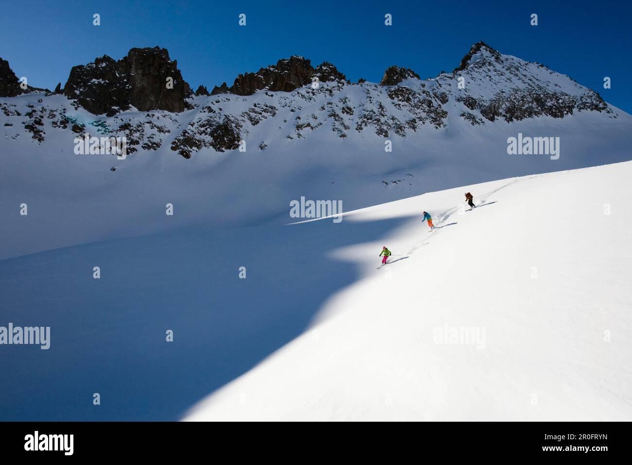 View of three people downhill skiing hi-res stock photography and ...
