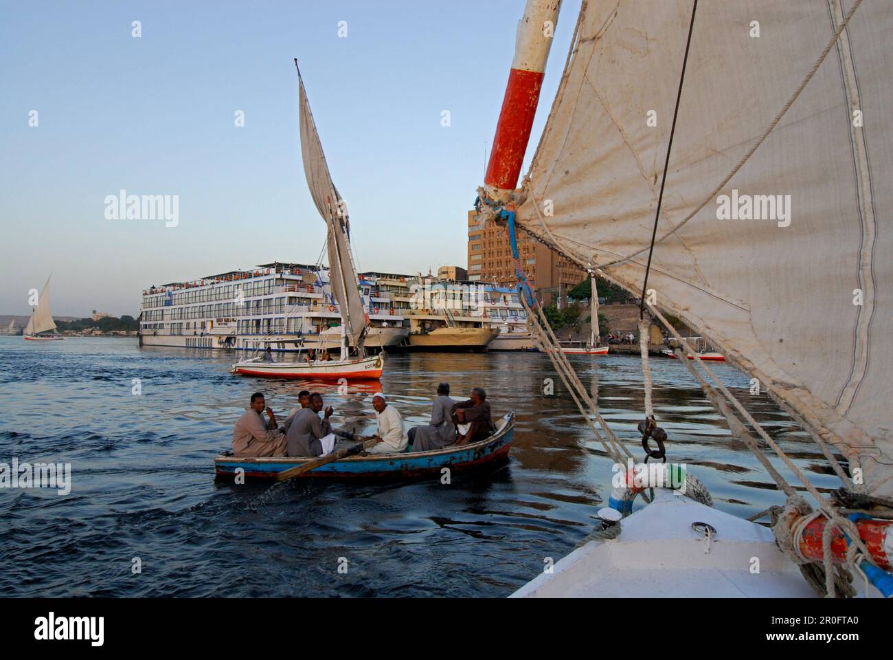 sailing boats (fellucas) on the Nile, cruise ships in Aswan, Egypt ...