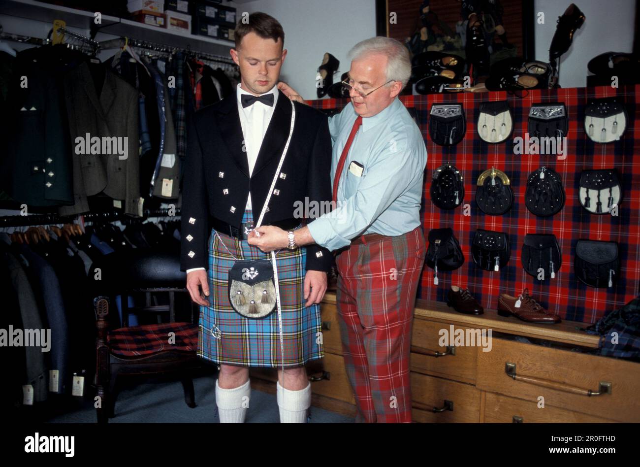 Tailor taking measurements for a jacket, traditional dress, Inverness ...