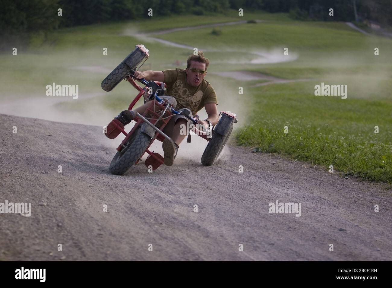 Man riding a bullcart, amusement park Brauneck, Lenggries, Bavaria ...
