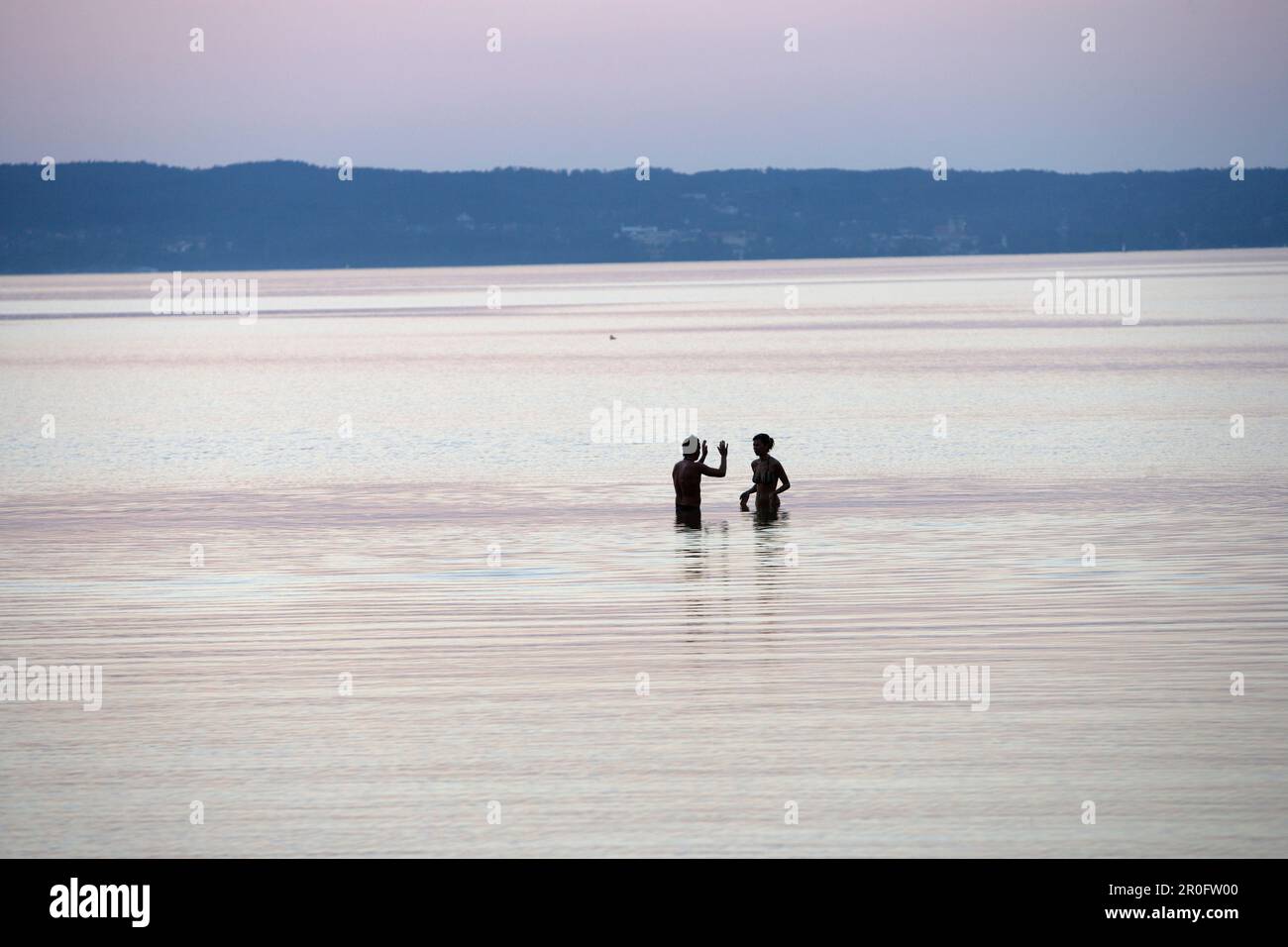 Couple bathing in Lake Starnberg, Ambach, Munsing, Bavaria, Germany ...