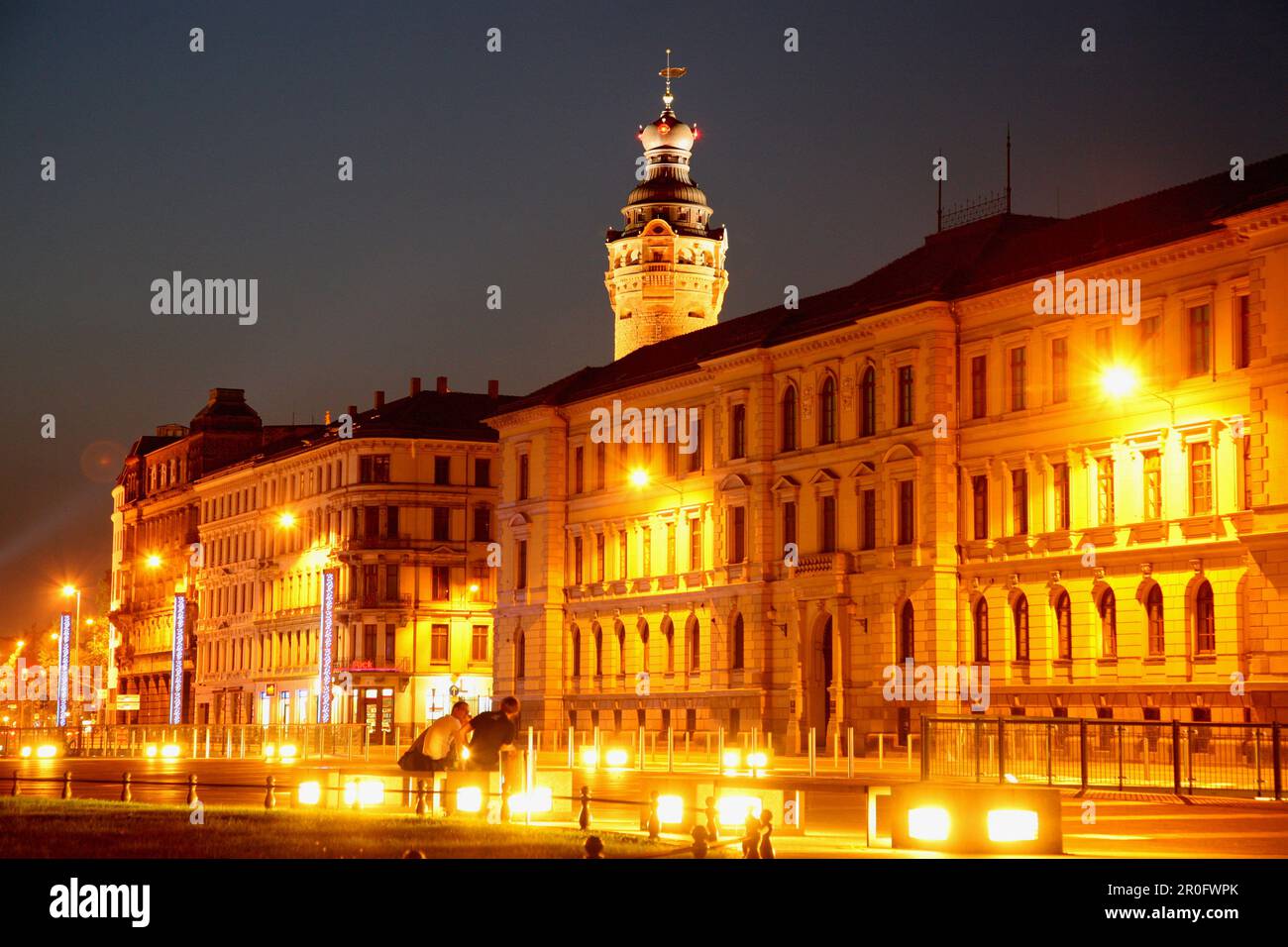 Illuminated street at night, city hall tower in background, Leipzig ...