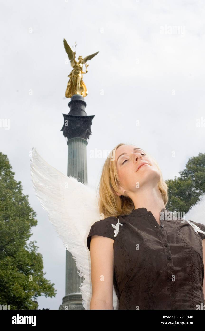 Angel, young woman with wings at the Friedensengel, Golden angel statue ...