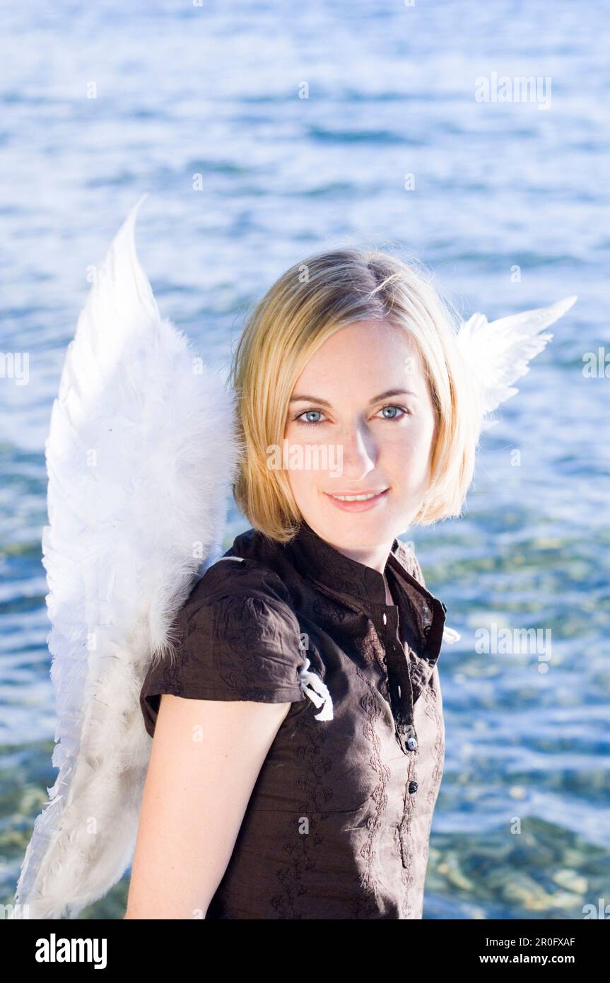 Angel, young woman with wings at Lake Starnberg, Bavaria, Germany Stock ...