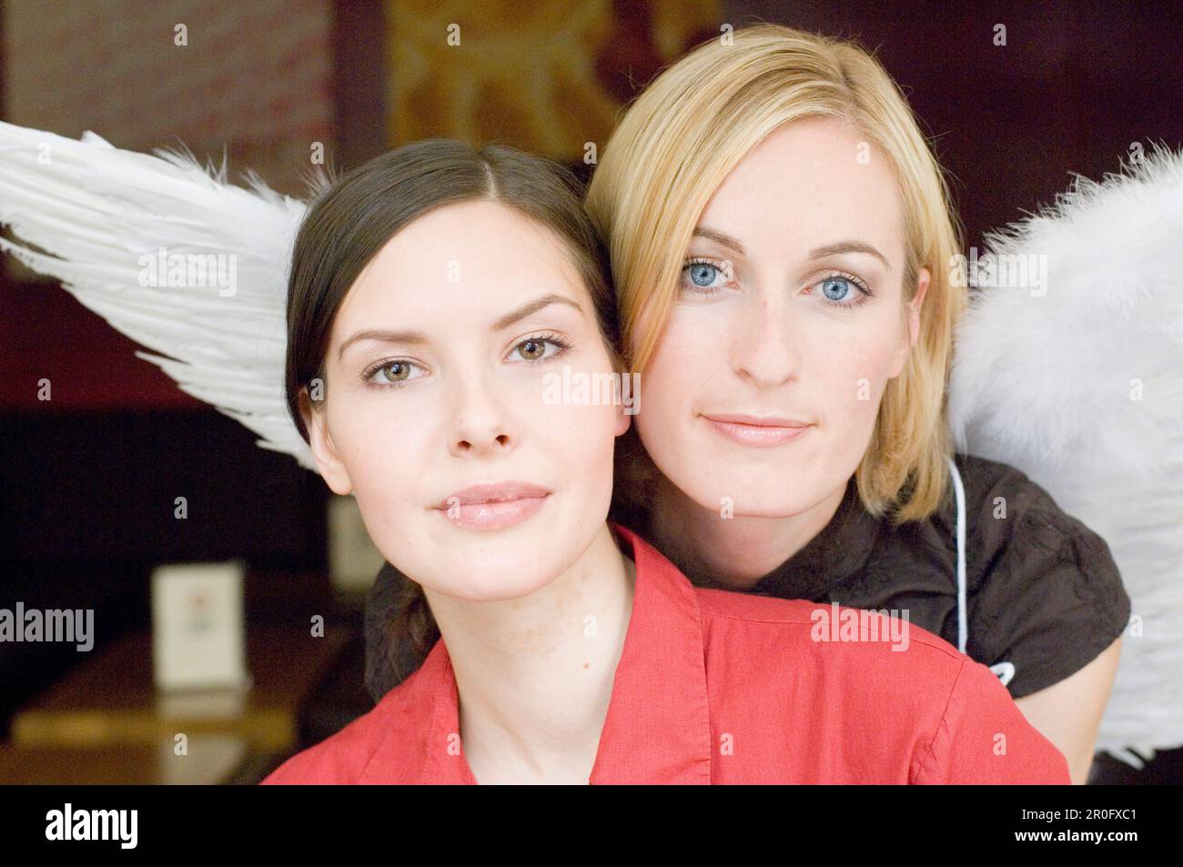 Angel, young woman with wings helping business woman in the office ...