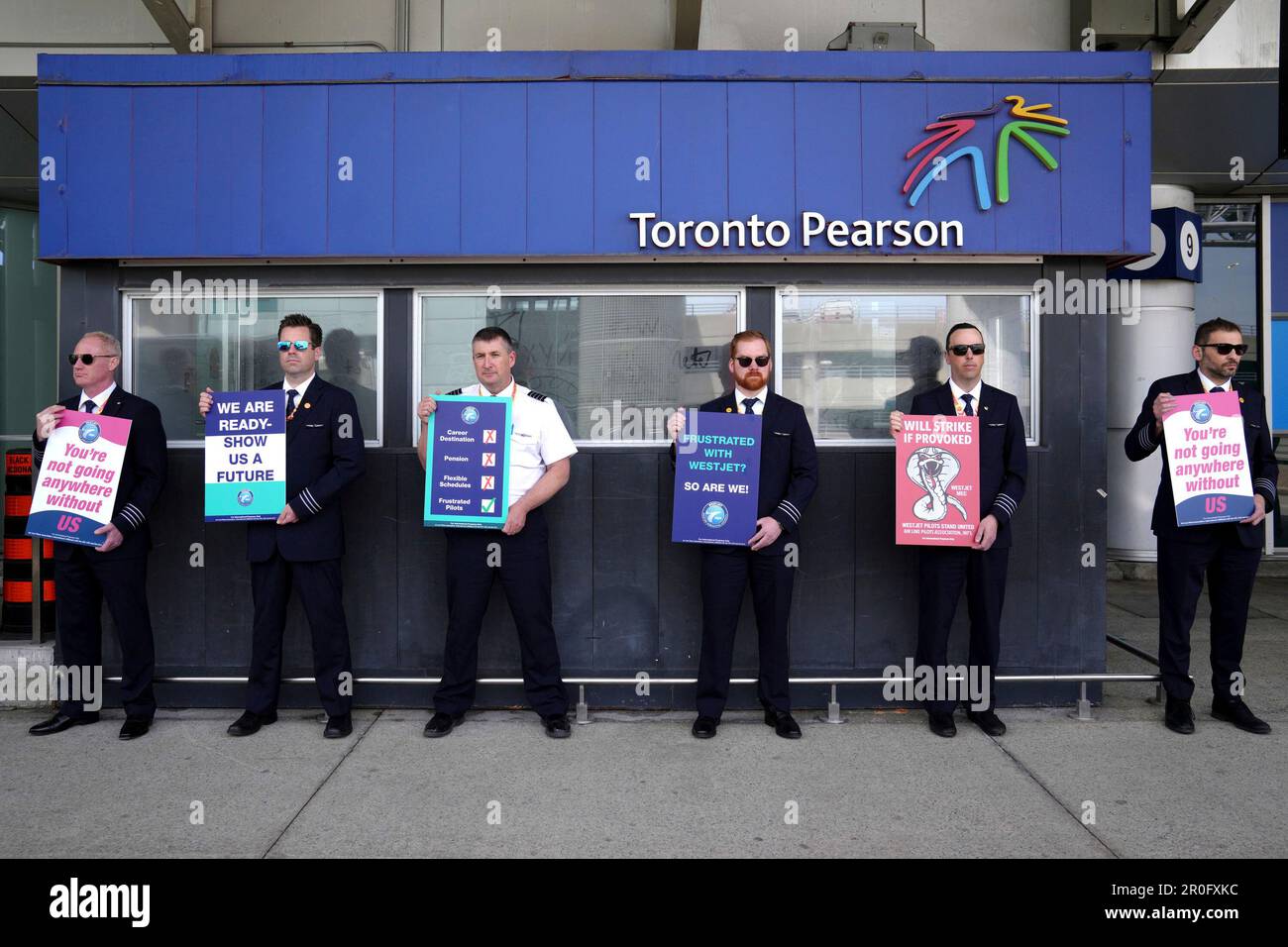 WestJet Airlines pilots stand on a picket line at Toronto's Pearson ...