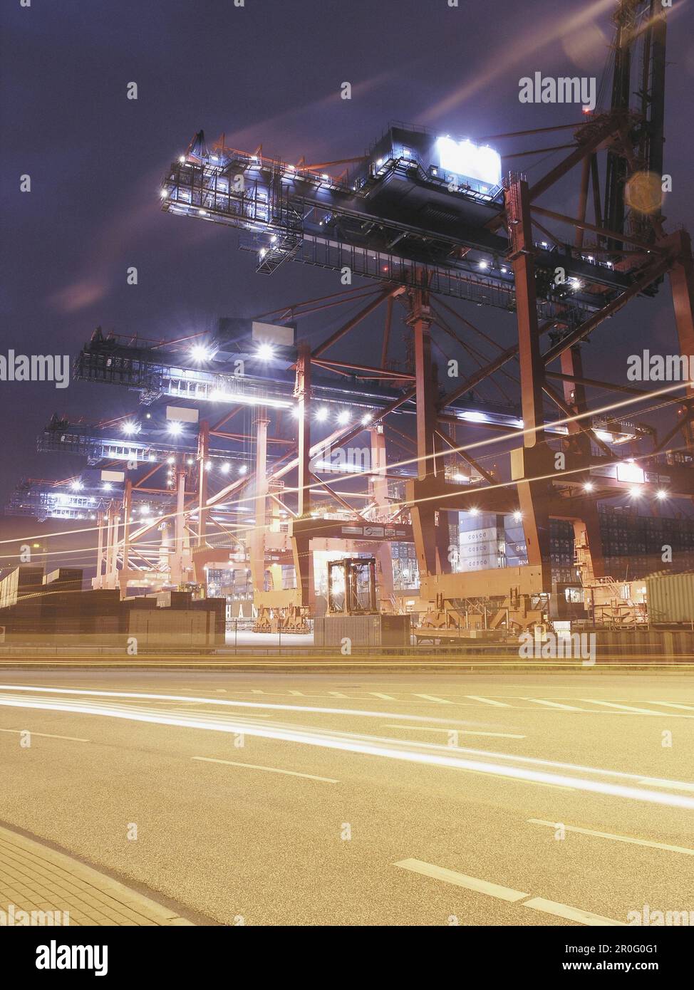 Container cranes in container port in the night, Hamburg, Germany Stock ...