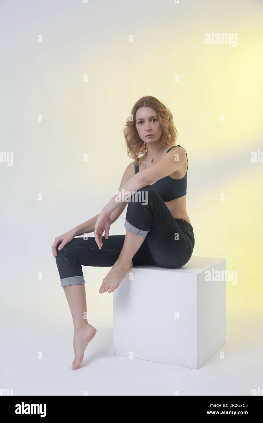 Fashion portrait of young woman in dark blue mini crop top and skinny ...