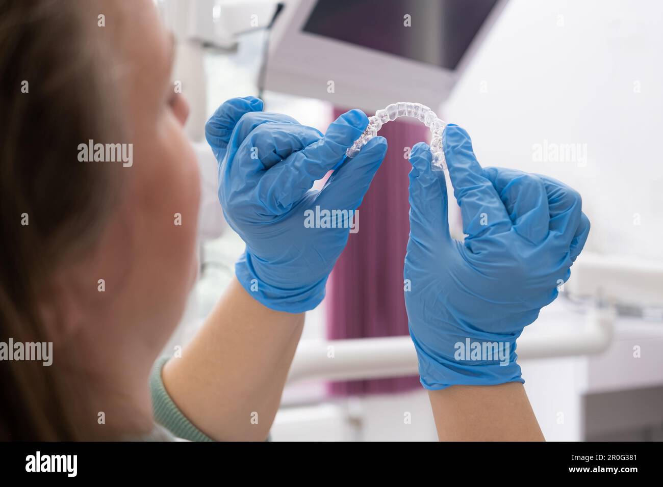 patient in dental clinic holding in hands and trying an invisible ...