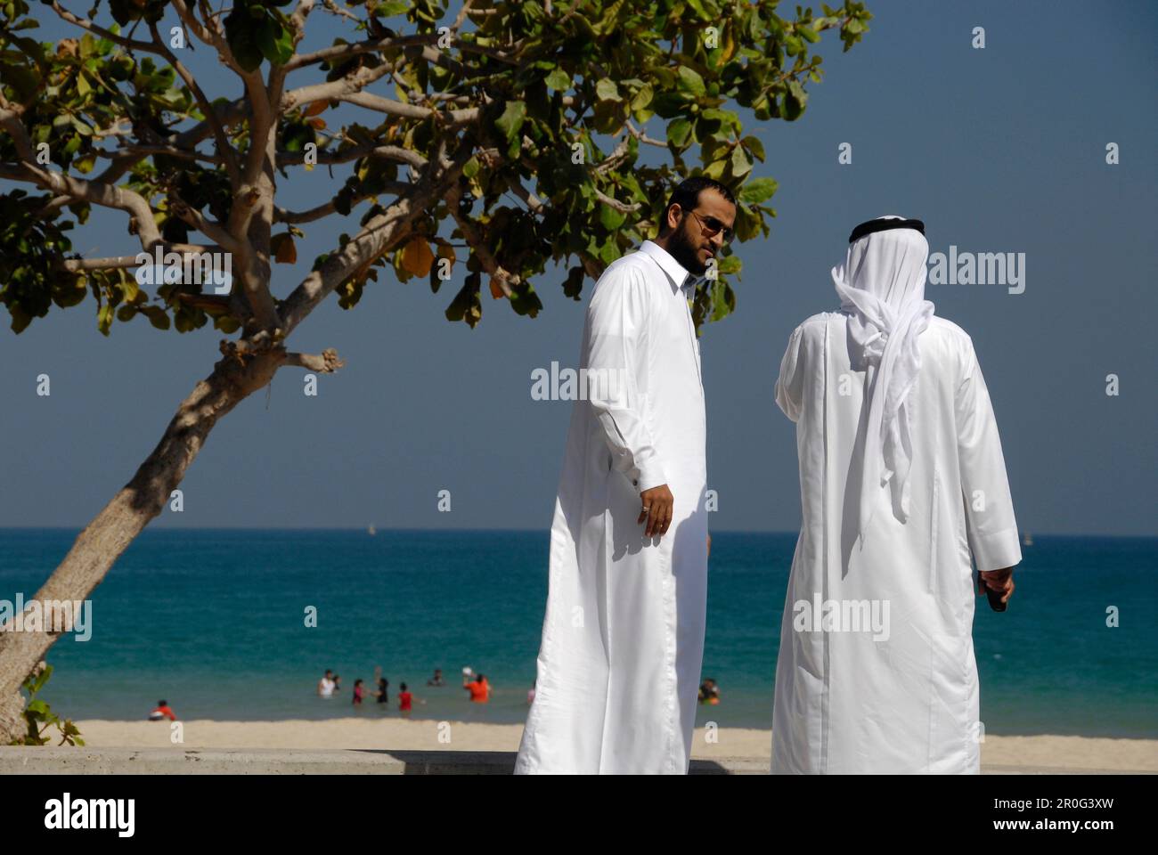 Two local men in front of the beach, Al Fujairah, United Arab Emirates ...