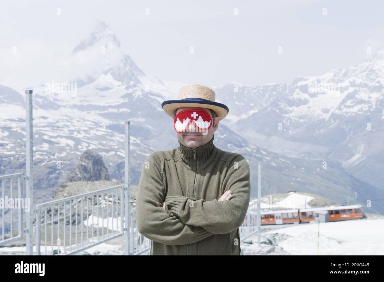 Mann wearing a sleeping mask, Mountain landscape, Valais, Switzerland ...