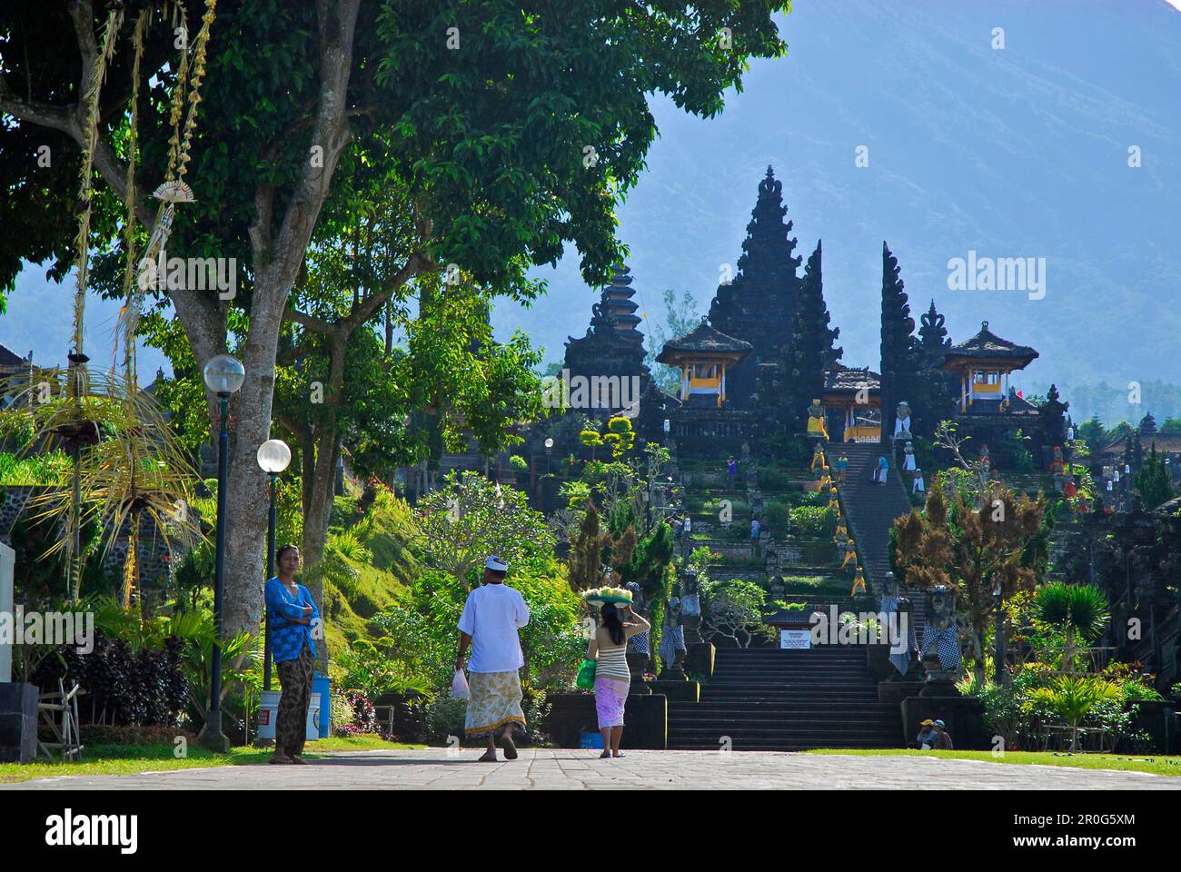 People on a street, in the background Besakih, the balinese main temple ...