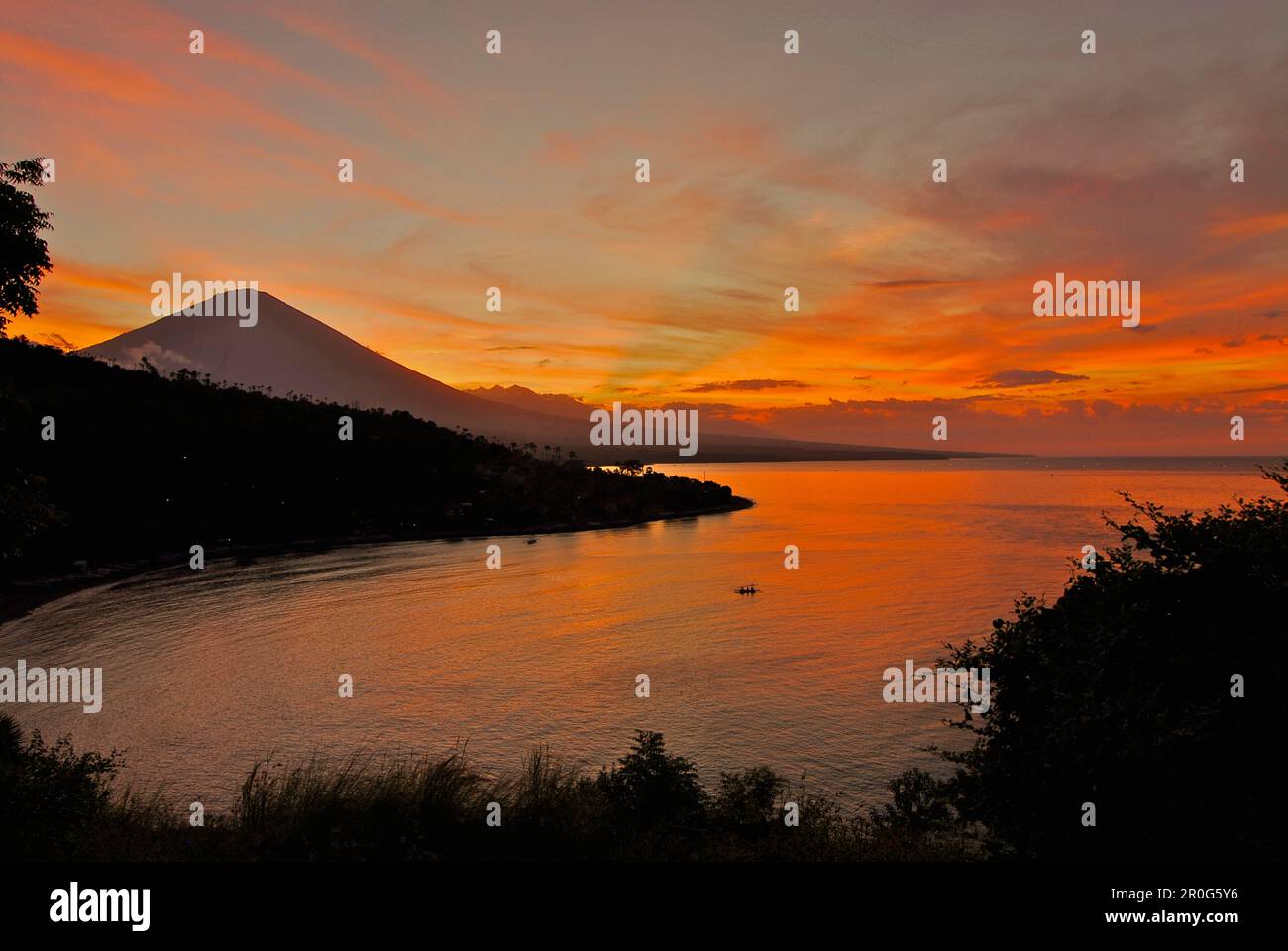 Sunset at the coast and view at Gunung Agung volcano, Bali, Indonesia ...
