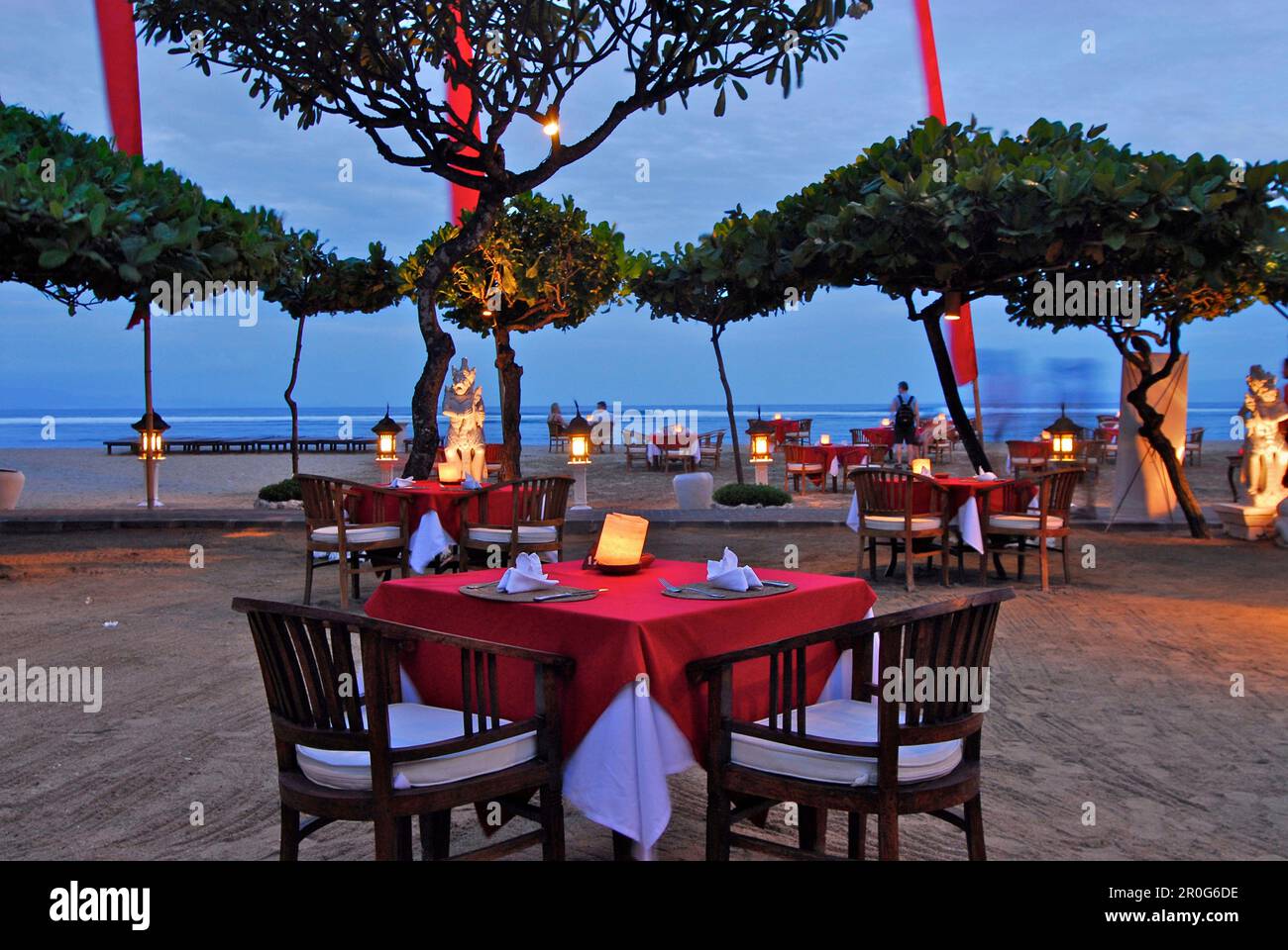 Tables are laid at the beach, restaurant of the La Taverna Hotel, Sanur ...