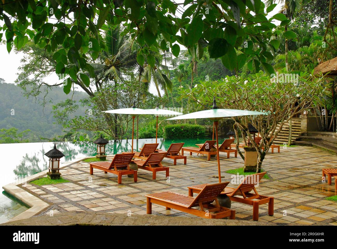 Sunloungers at the terrace next to the pool of the Amandari Resort, Yeh ...
