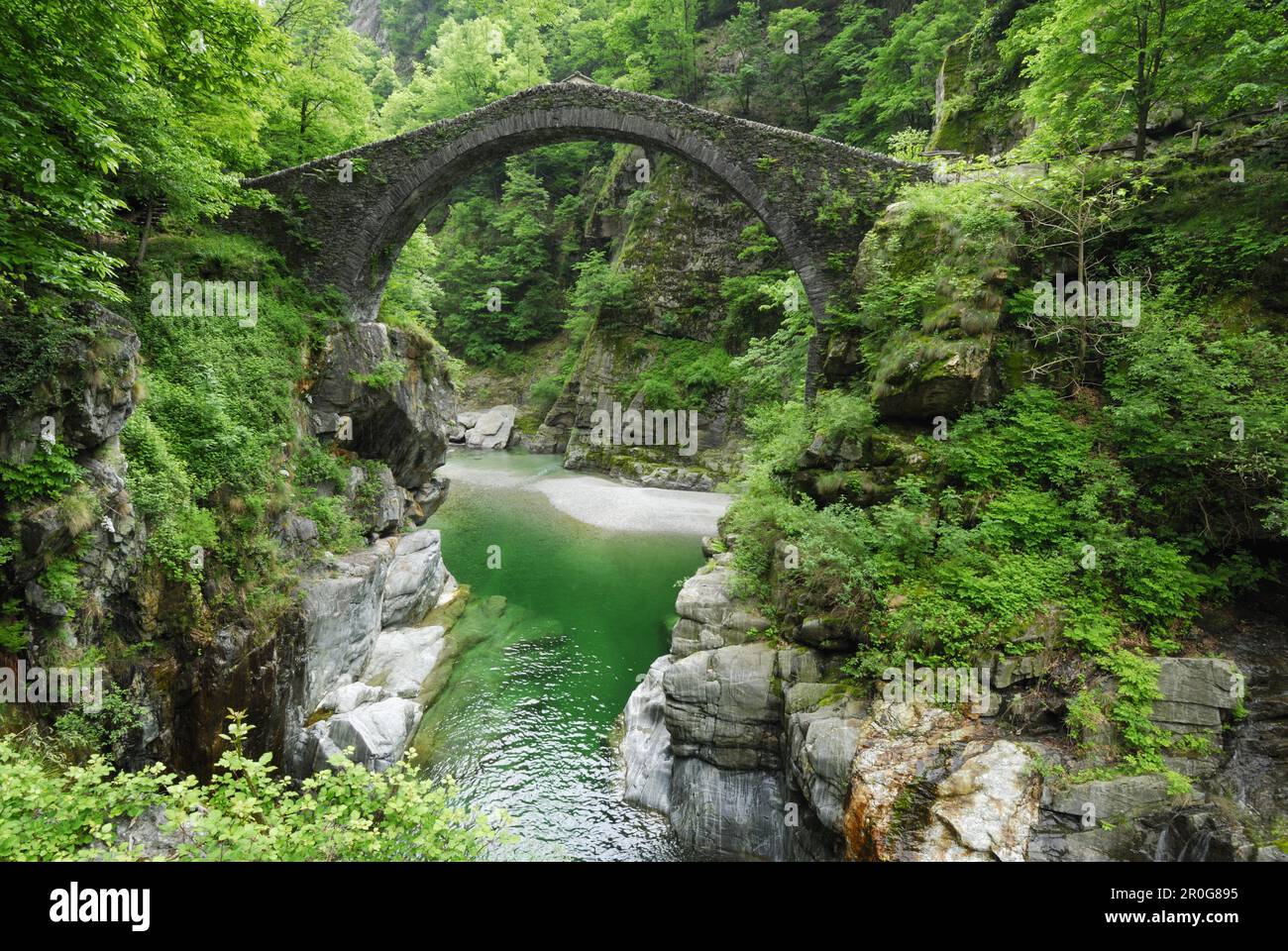 Stone arch bridge Ponte Romano over river Melezza, Intragna, Centovalli ...