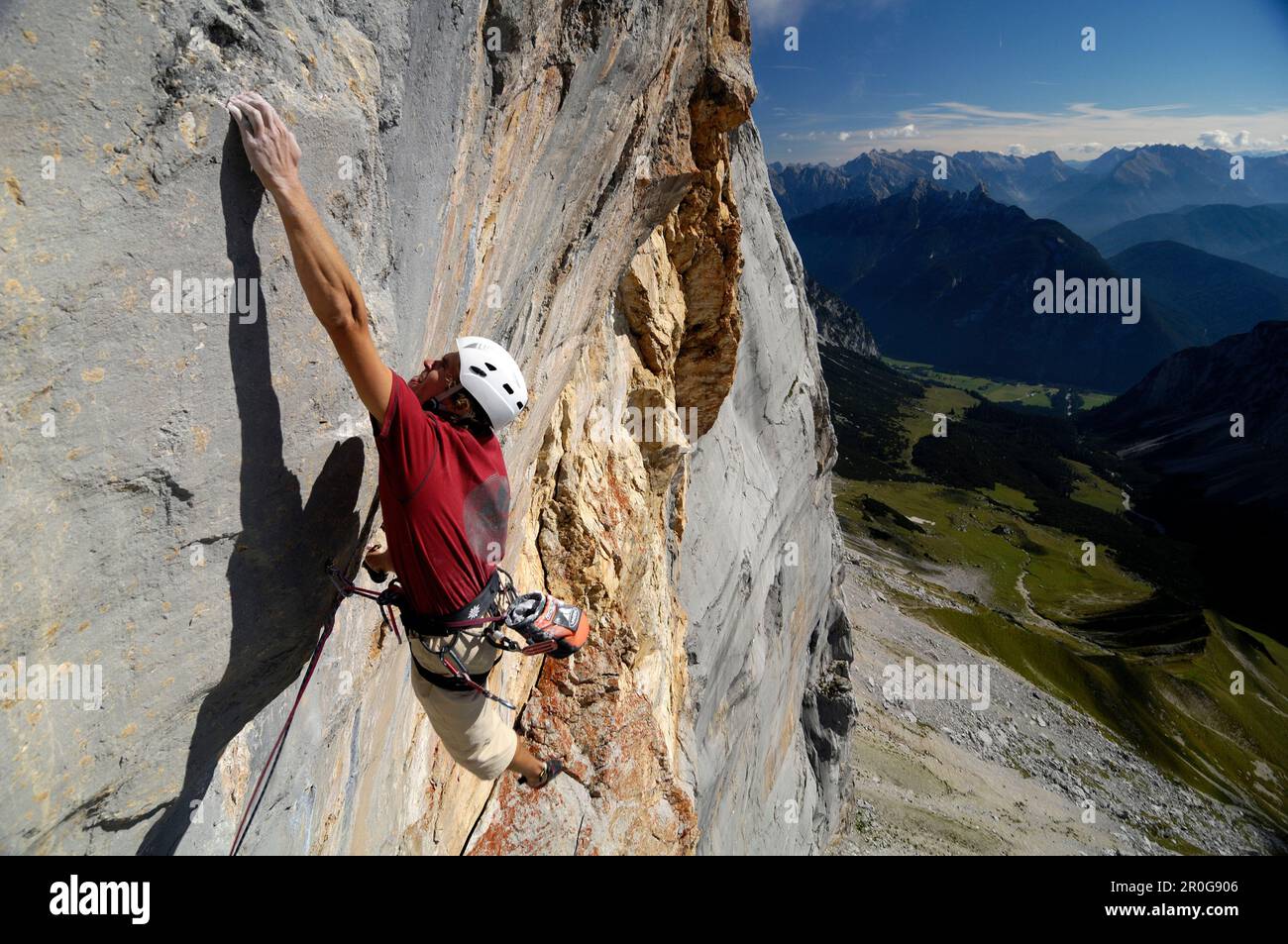 Climber at Schuesselkar rock face in the sunlight, Tyrol, Austria ...