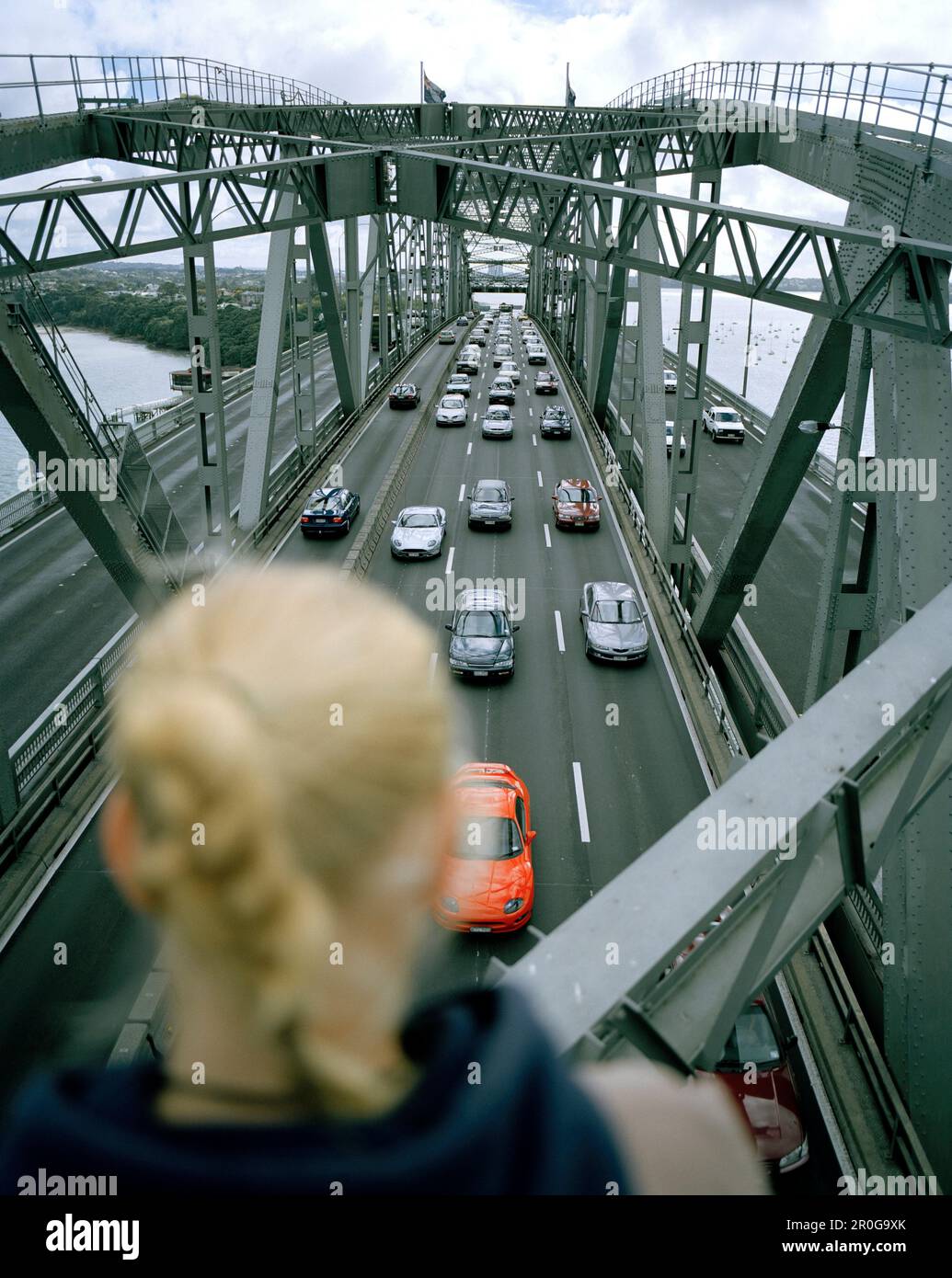 Young woman on steel arches of Harbour Bridge looking at the cars on ...